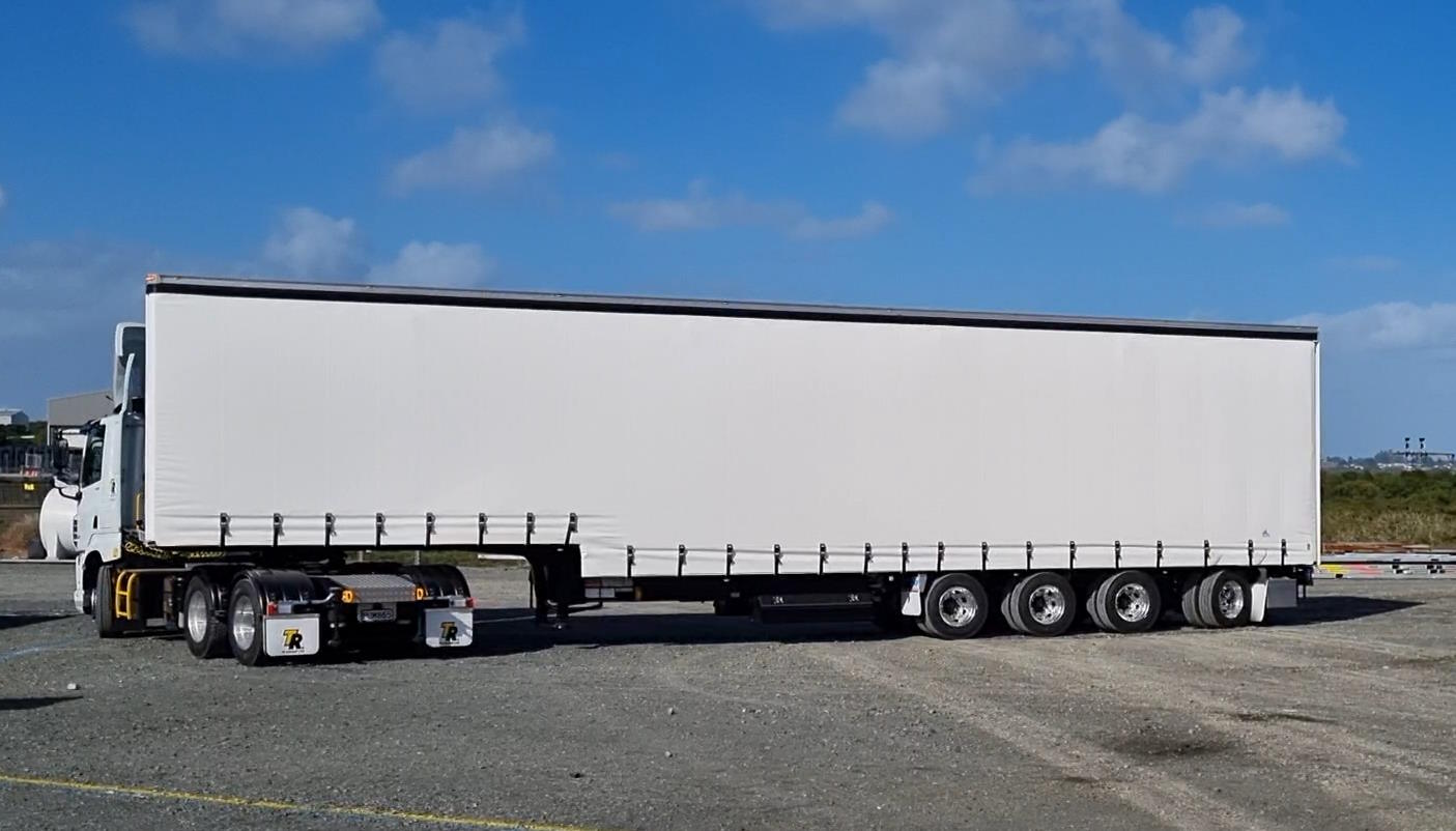 What are rear-steer axles and why are they used?